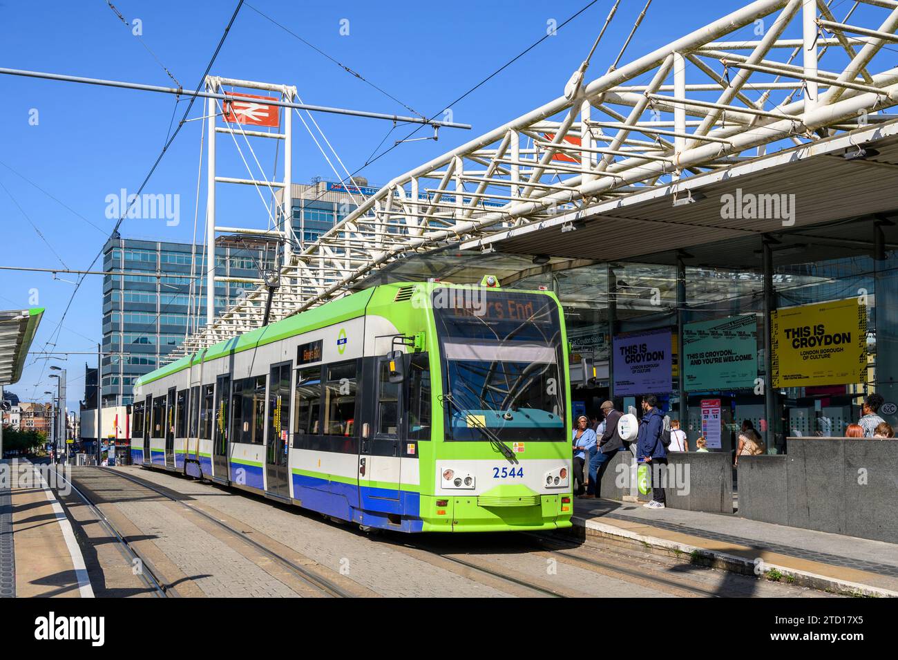London Trams tram waiting at a stop outside East Croydon railway ...
