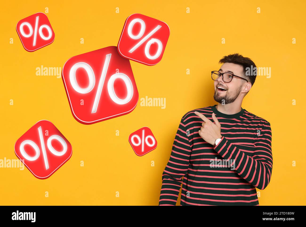 Discount offer. Happy man pointing at falling cubes with percent signs ...