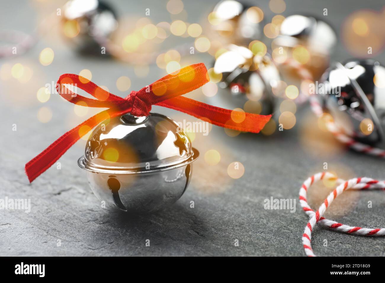 Christmas music. Jingle bells on grey table, bokeh effect Stock Photo ...