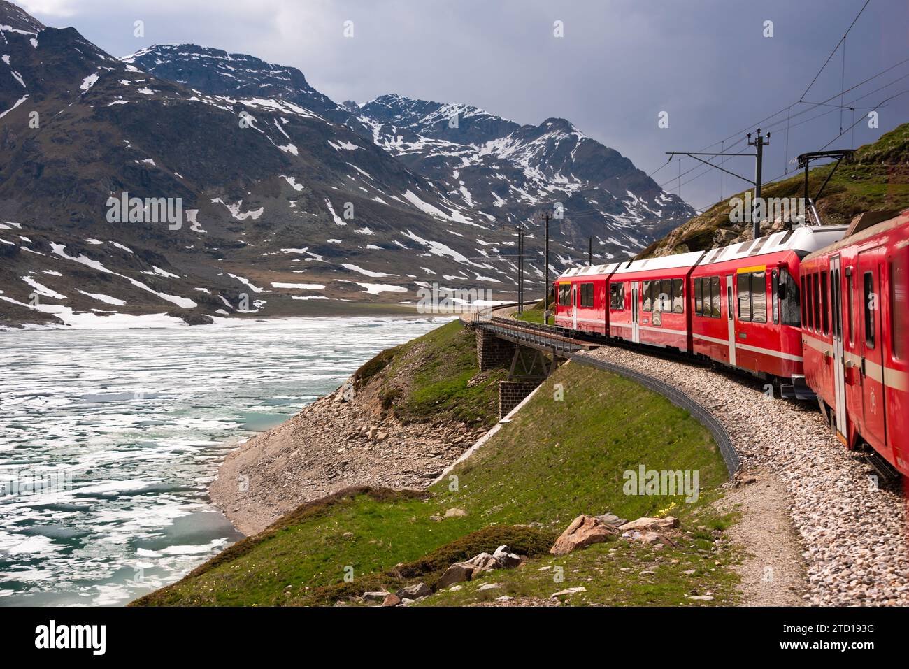 Red train going in beautiful landscape, Switzerland Stock Photo - Alamy