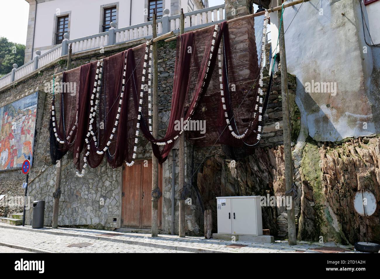 traditional fishing nets hanging up to dry in the pretty village of ...