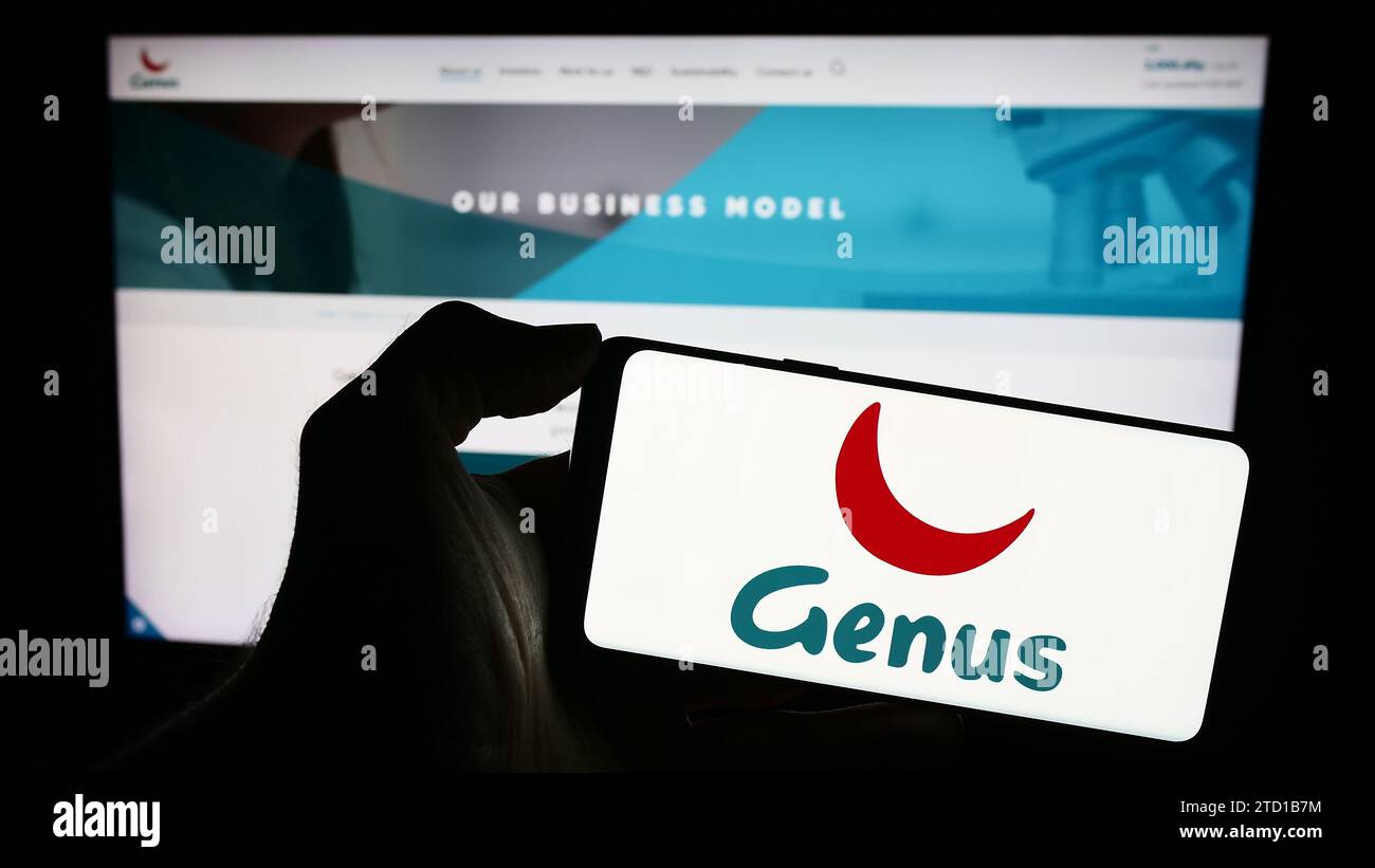 Person holding smartphone with logo of British elite genetics company ...