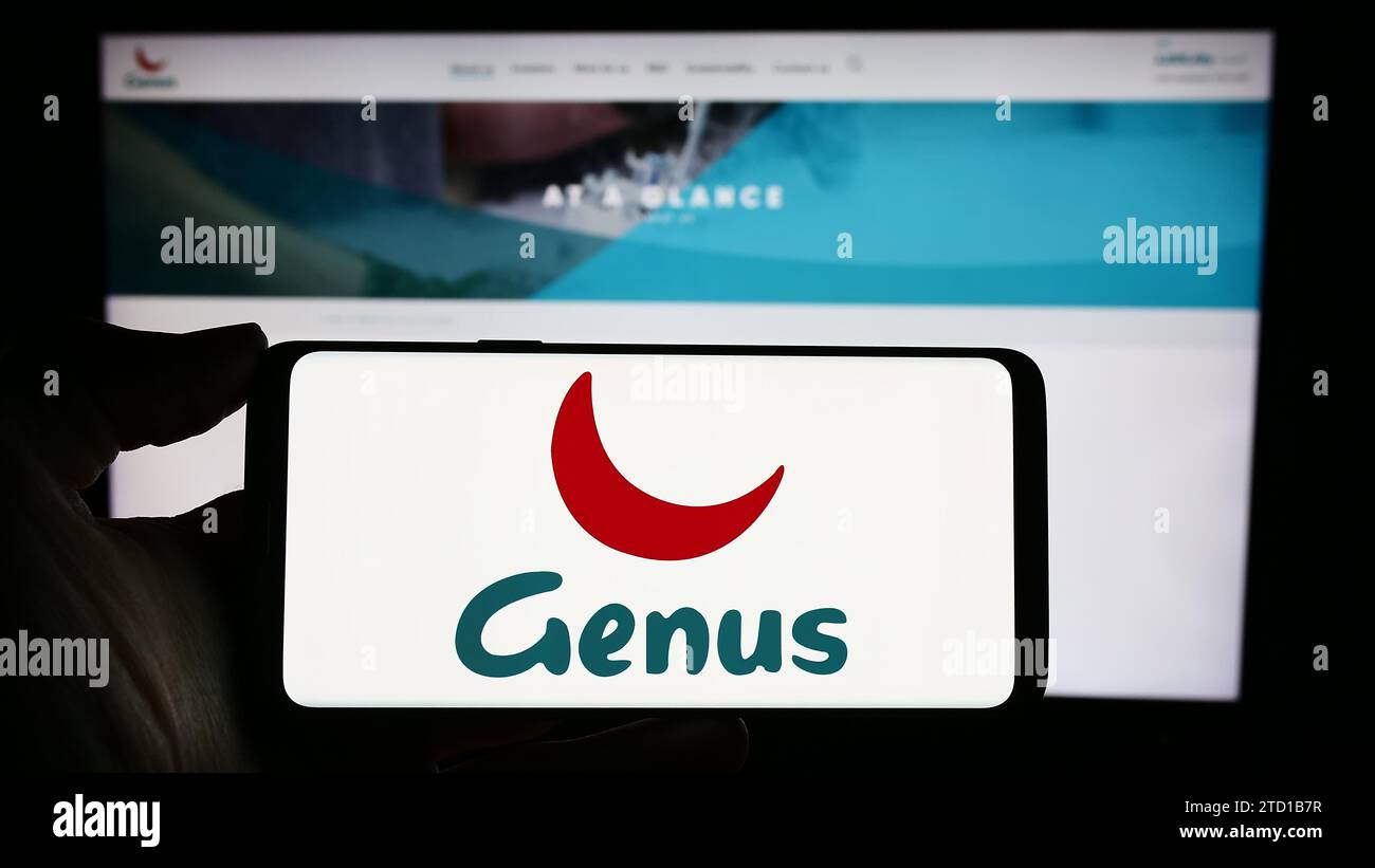 Person holding cellphone with logo of British elite genetics company ...