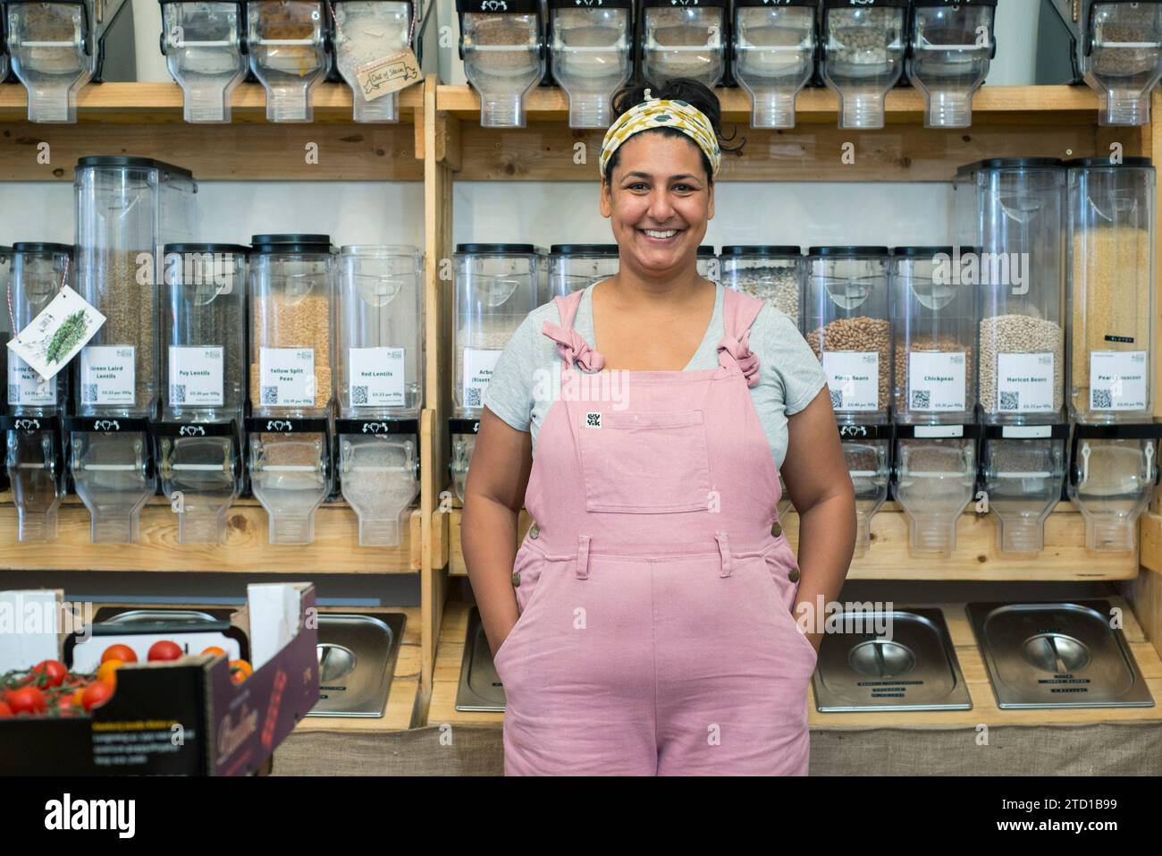 A young woman and business owner stands in her environmentally friendly ...
