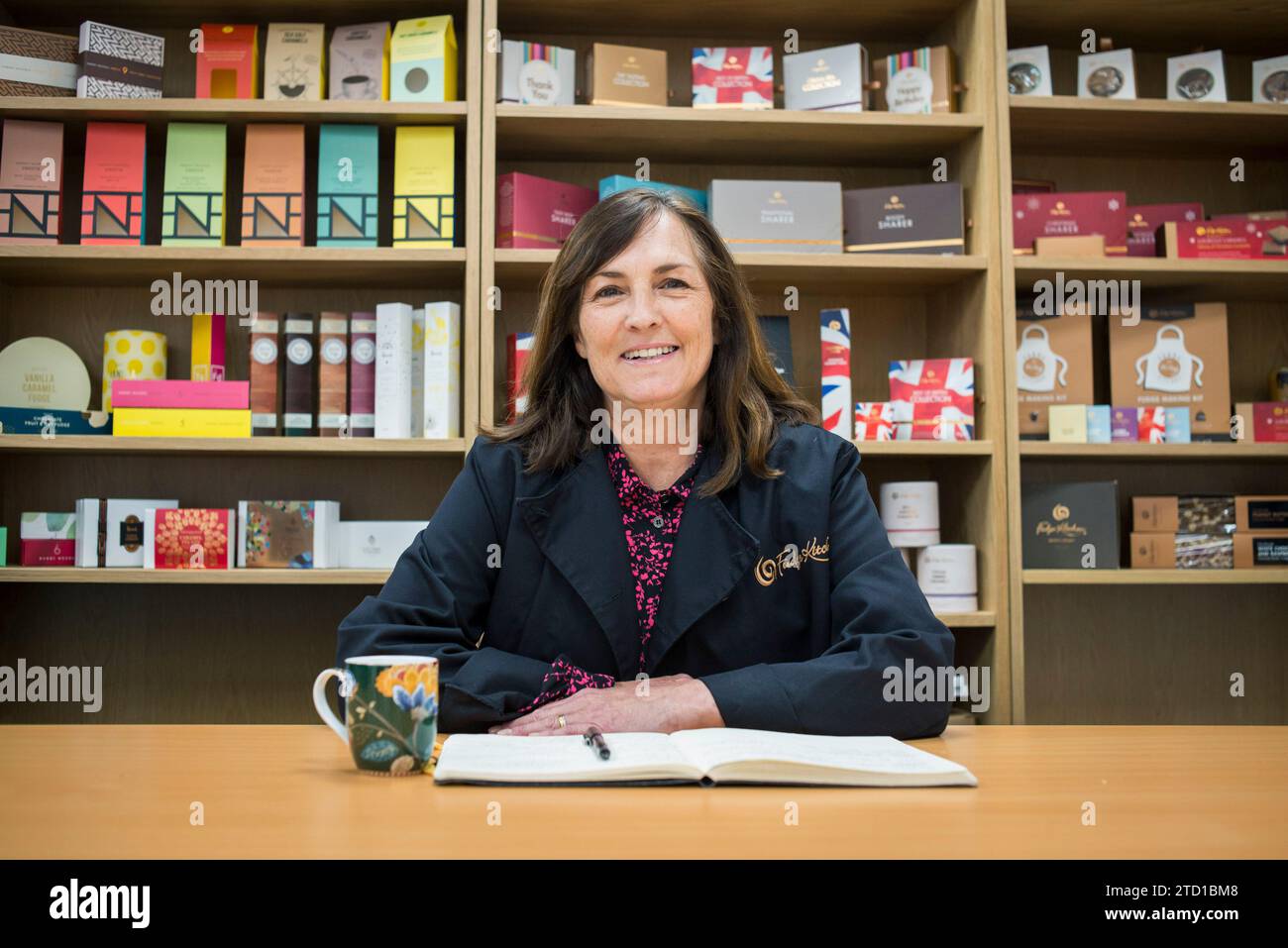 A female company owner poses for a portrait in her business premises ...