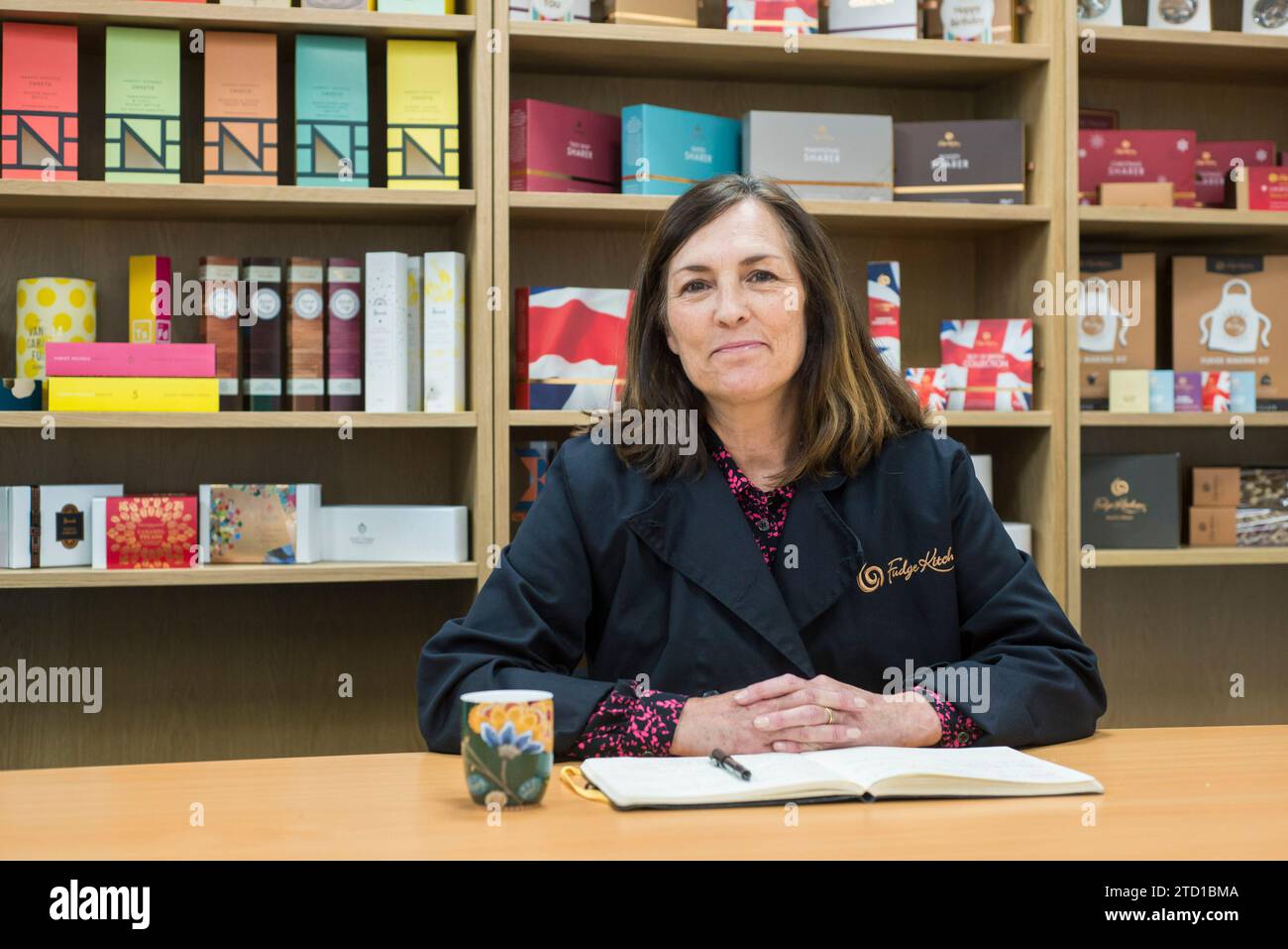A female company owner poses for a portrait in her business premises ...