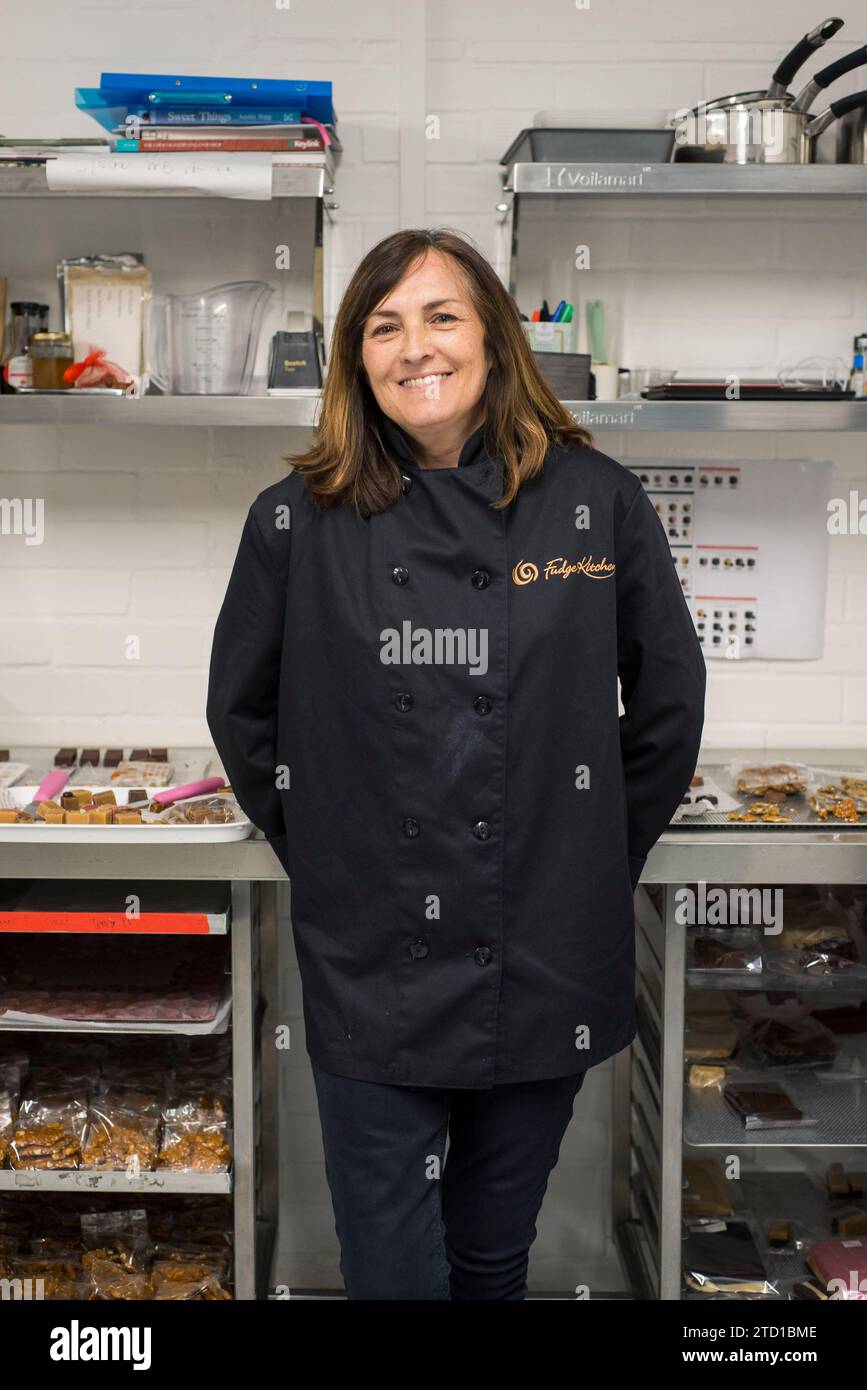 A female company owner poses for a portrait in her business premises ...