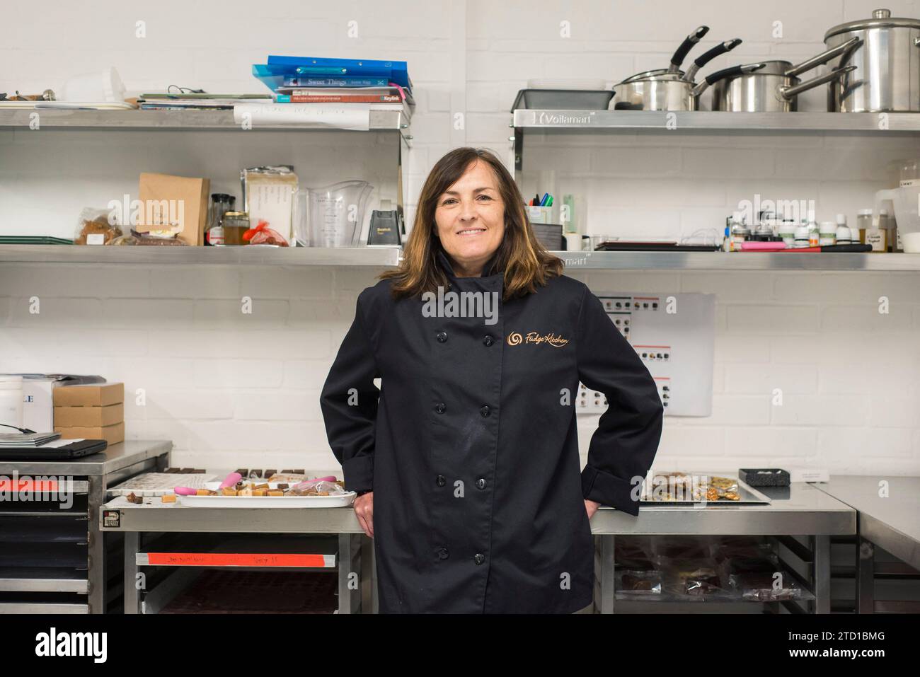 A female company owner poses for a portrait in her business premises ...