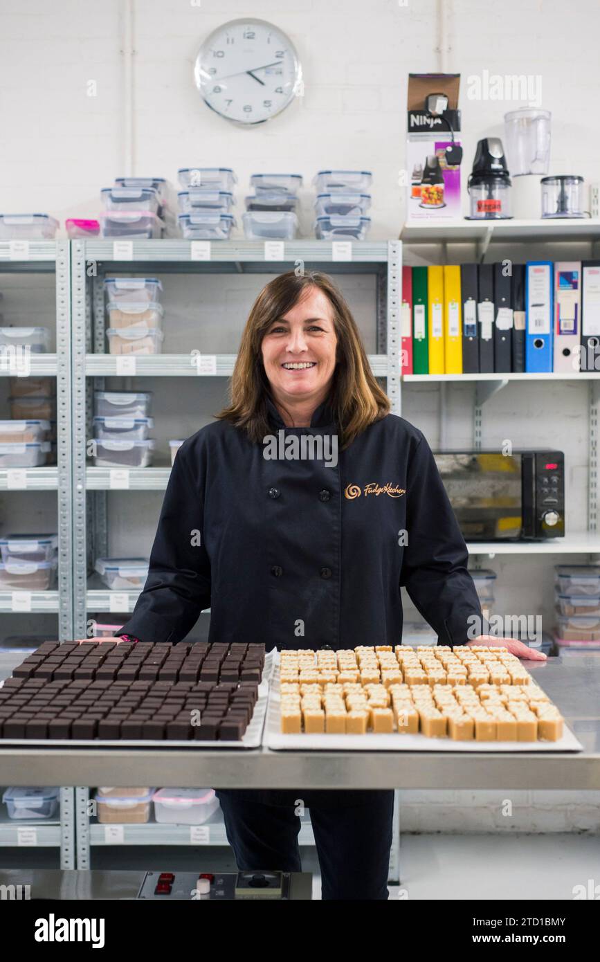 A female company owner poses for a portrait in her business premises ...
