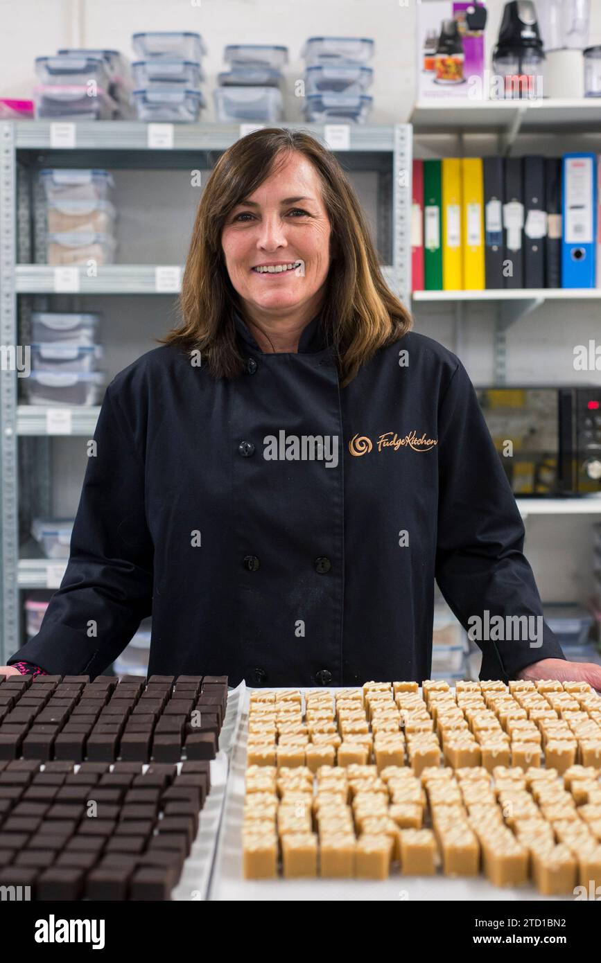 A female company owner poses for a portrait in her business premises ...