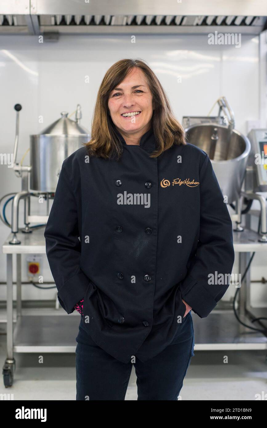 A female company owner poses for a portrait in her business premises ...