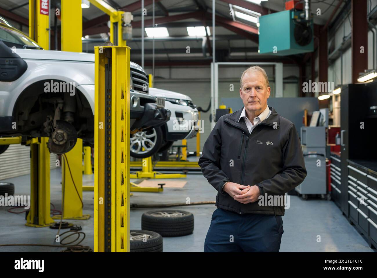 A Land Rover garage owner stands in his mechanics workshop for a ...