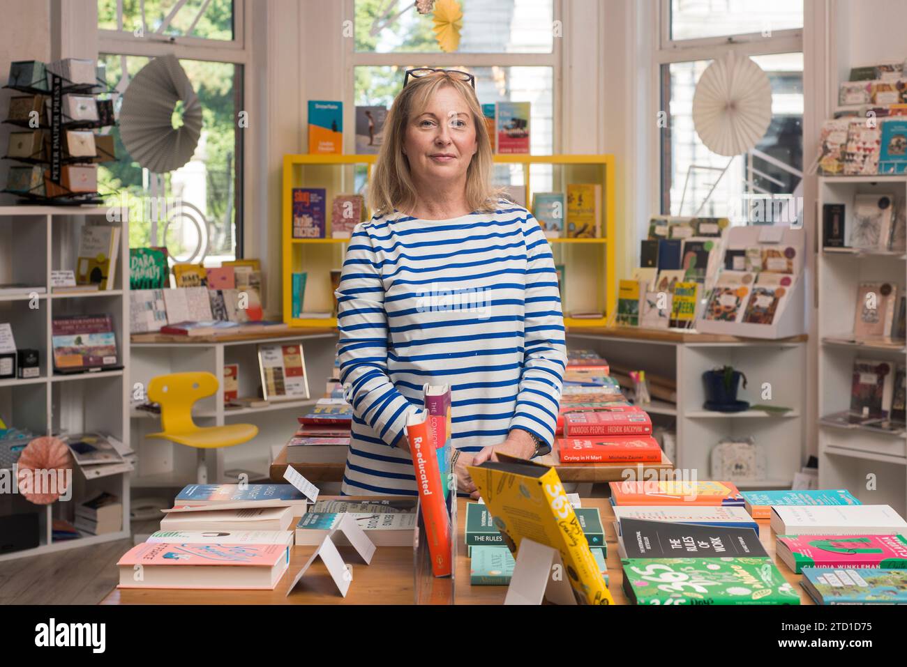 A portrait of a small business owner in her local high street book shop ...