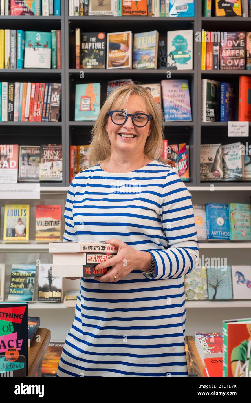 A portrait of a small business owner in her local high street book shop ...