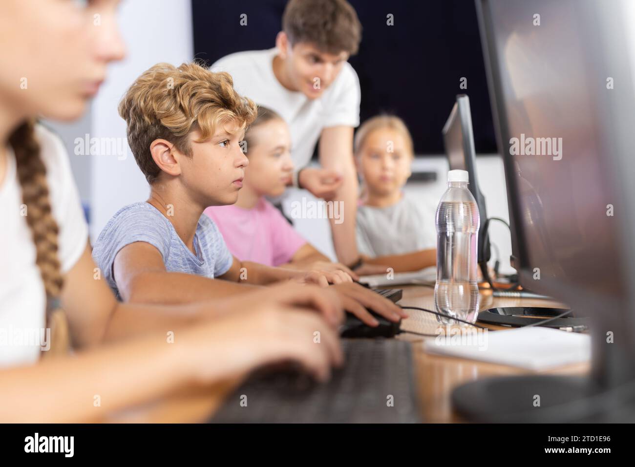 Boy student learning to work on computer in classroom Stock Photo - Alamy