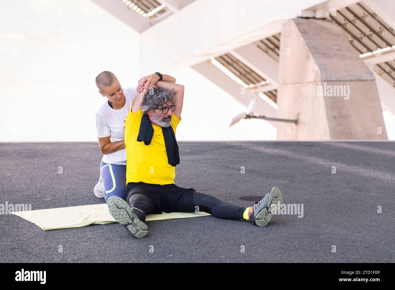 senior man stretching arms with personal trainer Stock Photo - Alamy