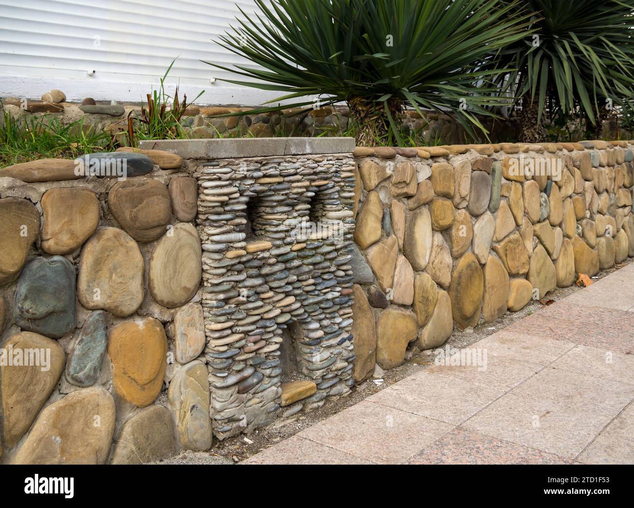 Decorative retaining wall made of various stones Stock Photo - Alamy