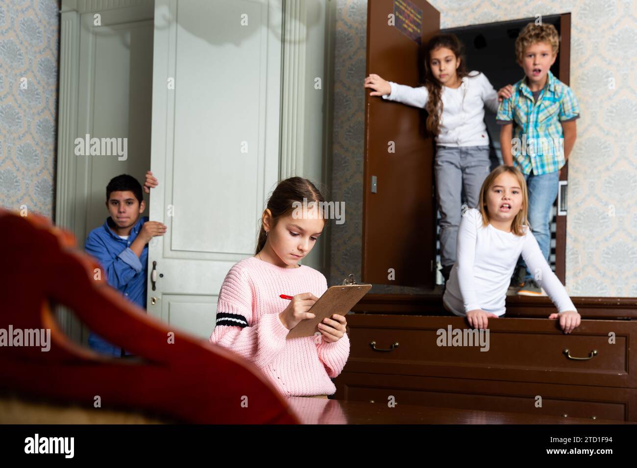 Focused tween girl trying to solve riddles in quest room Stock Photo ...