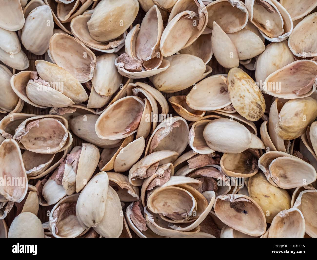 Large pile of empty pistachio shells eaten pistachios remains closeup ...