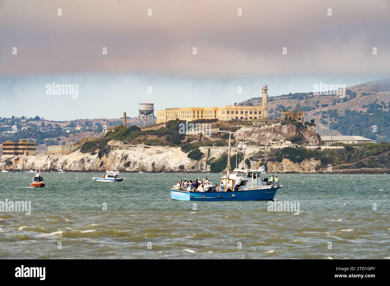 alcatraz island and prison with tourist boats on san francsico bay with ...