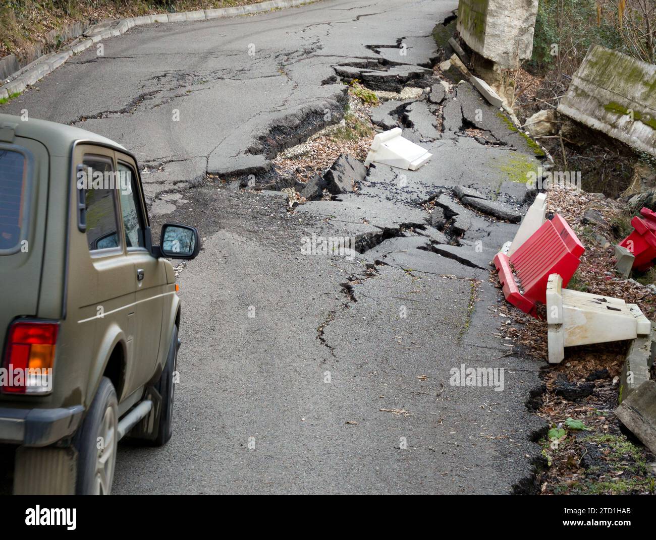 A car drives along a destroyed asphalt road in Sochi Stock Photo - Alamy