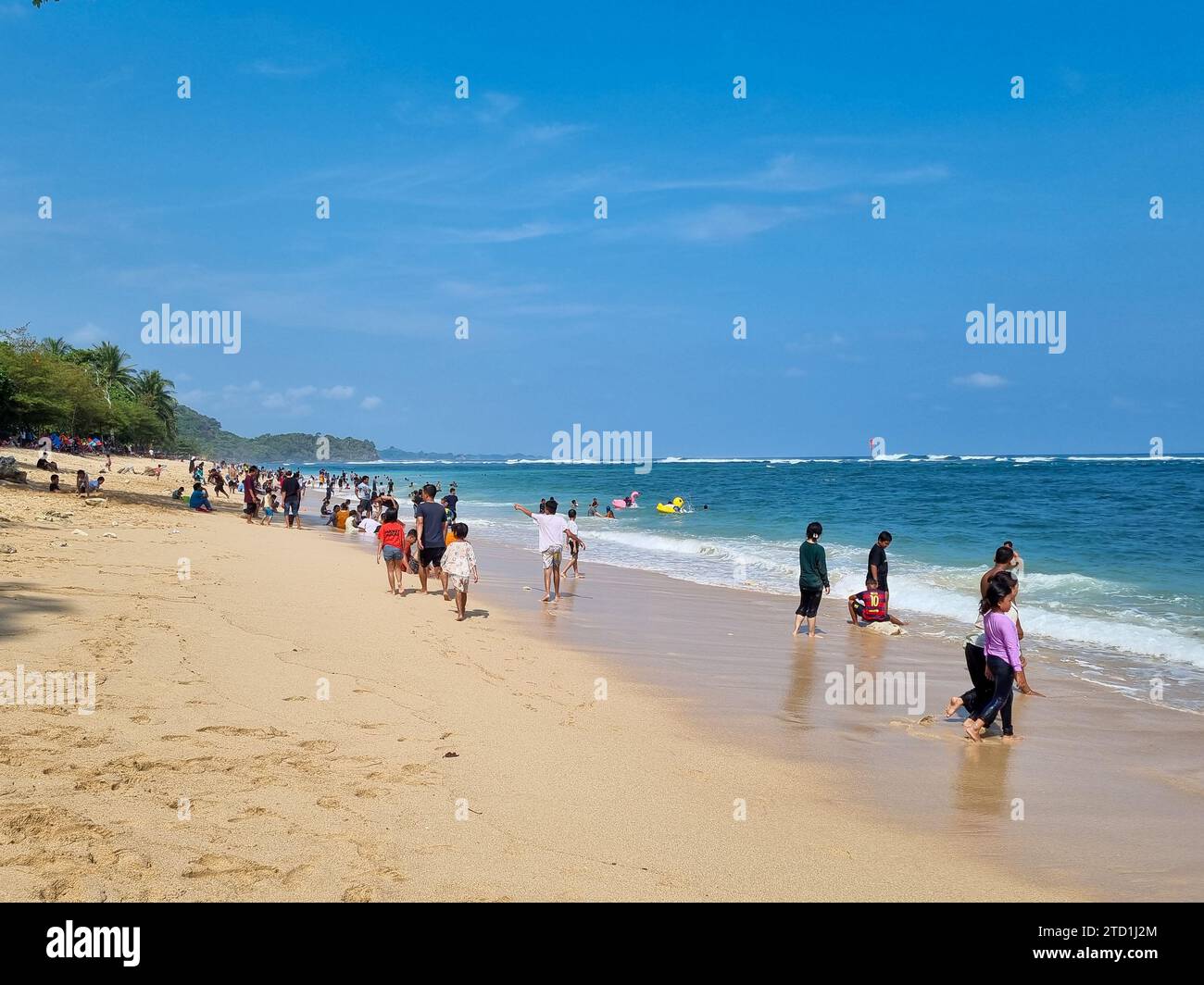 Tourists enjoy playing on the beach. Landscape view of Balekambang ...
