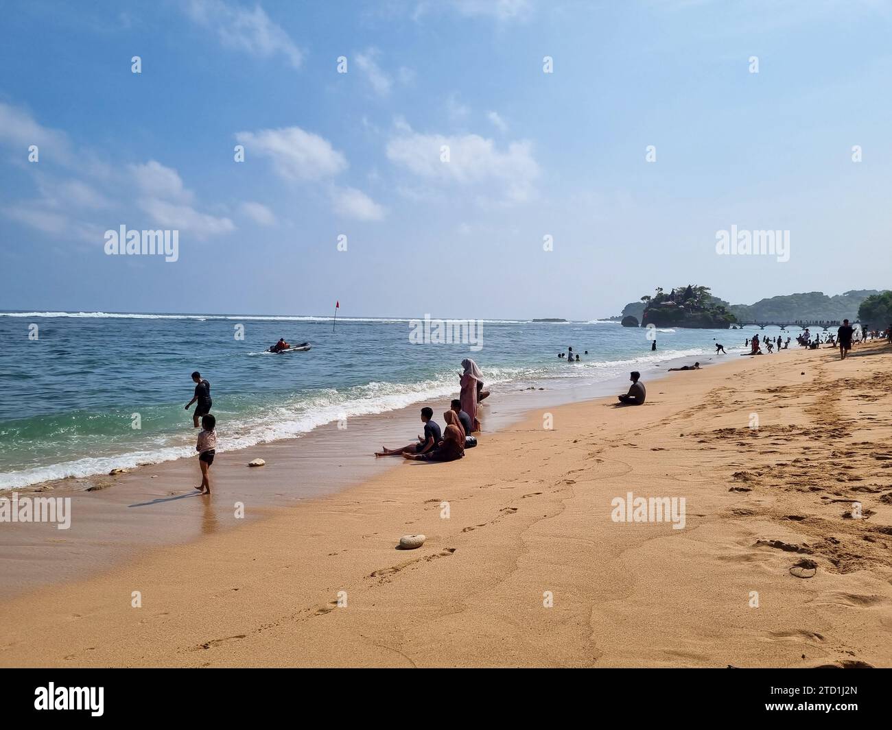 Tourists enjoy playing on the beach. Landscape view of Balekambang ...