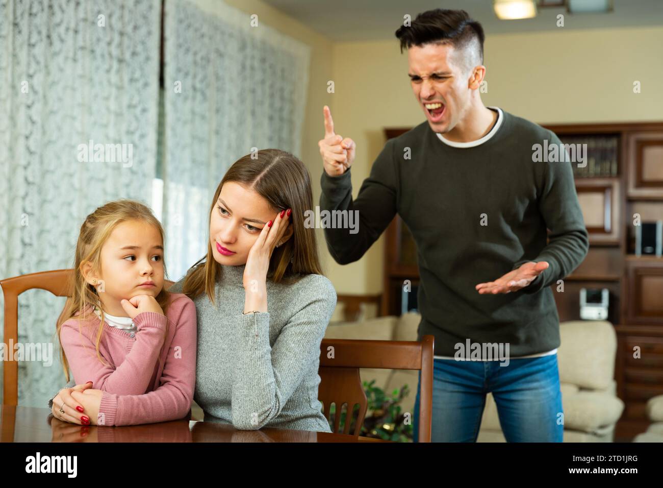 Frustrated woman and daughter with irritated father Stock Photo - Alamy