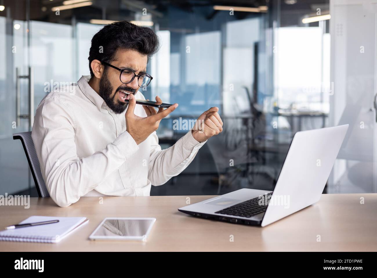 Angry Muslim young male businessman talking nervously on the phone ...