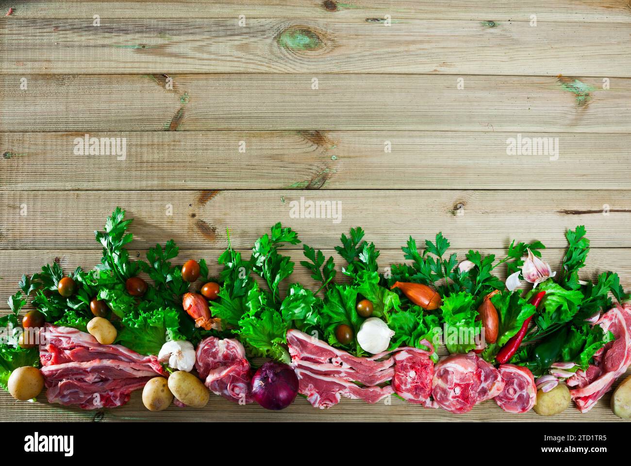 Raw mutton and vegetables assortment on natural wooden background Stock ...