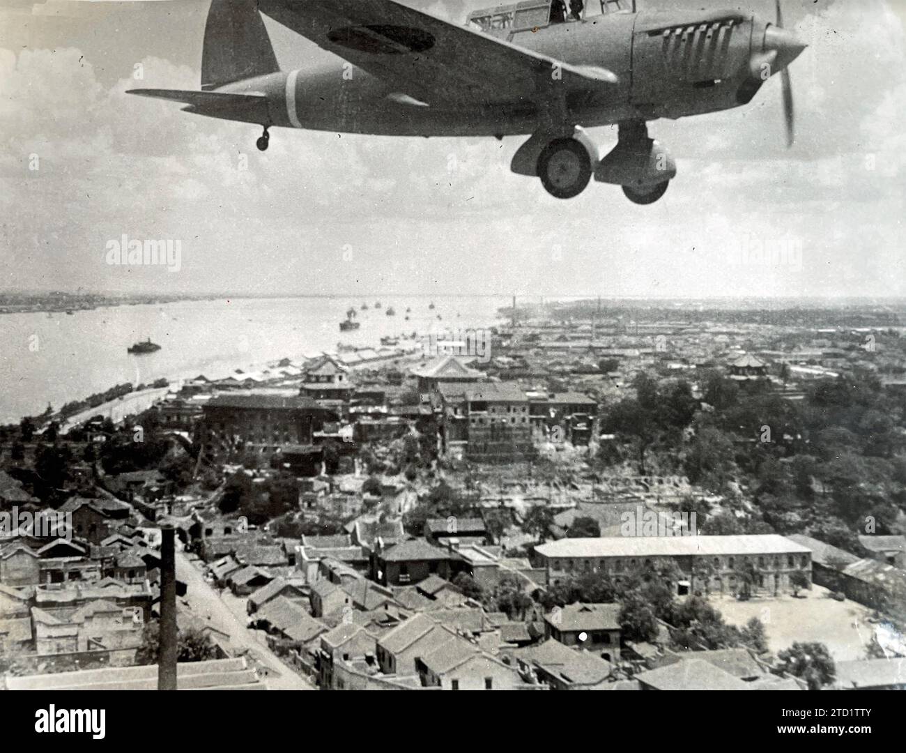 SINO-JAPANESE WAR 1937-1945. A Japanese mail plane flies over Canton and the Pearl River about ...