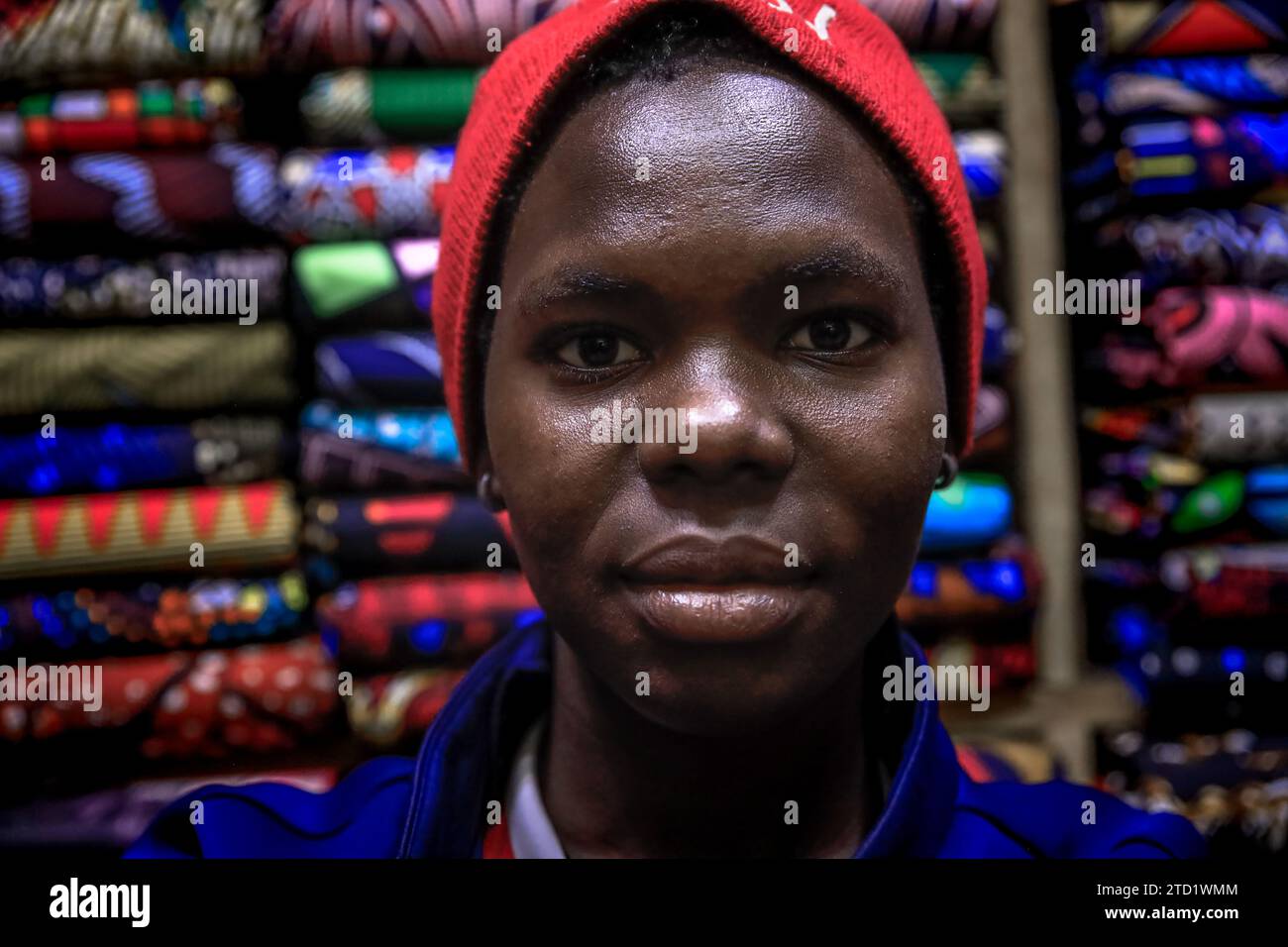 A trader is paused for a photo at a fabric shop in Biashara Street on ...