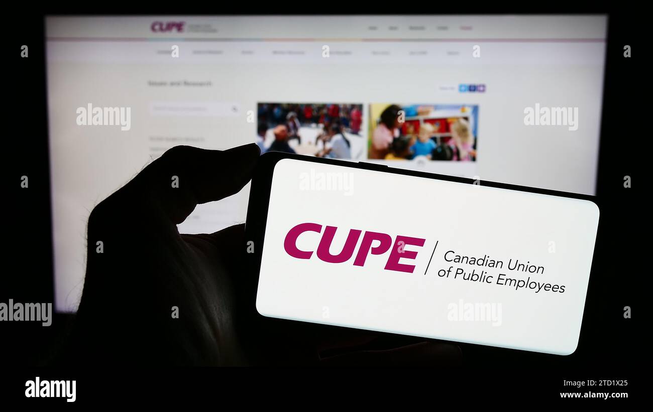 Person holding mobile phone with logo of trade union Canadian Union of Public Employees (CUPE ...