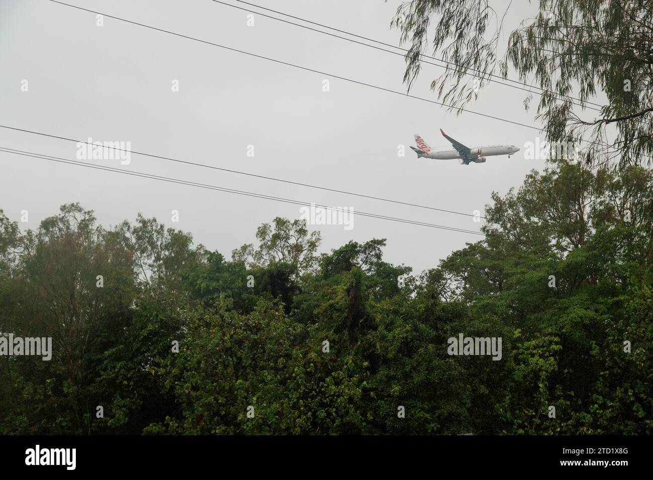 A Virgin Airlines jet flies over a flooded field in the northern ...