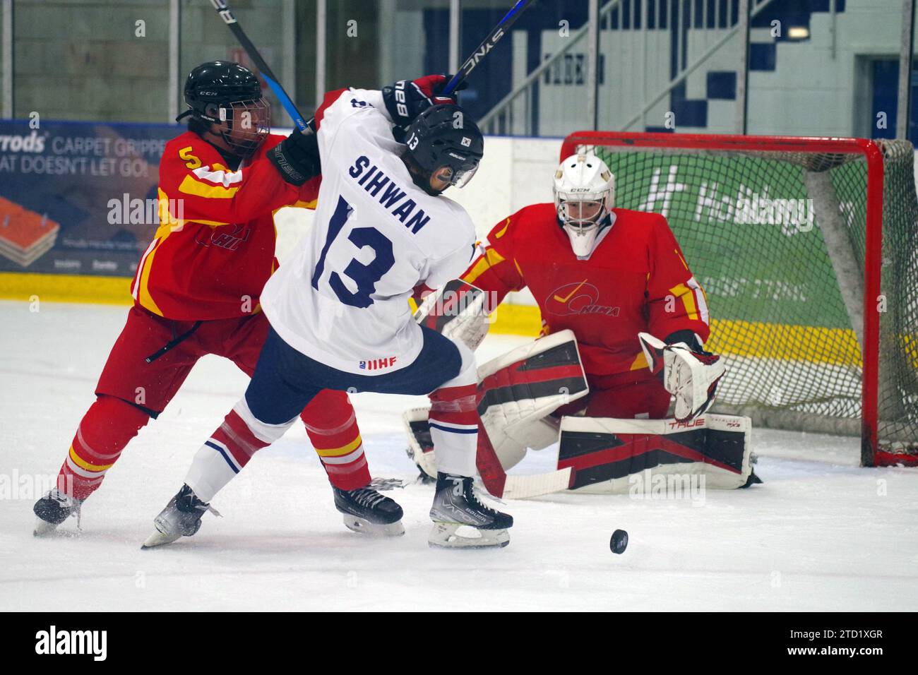 Dumfries, 15 December 2023. Song Jianuo and netminder Chen Shifeng ...