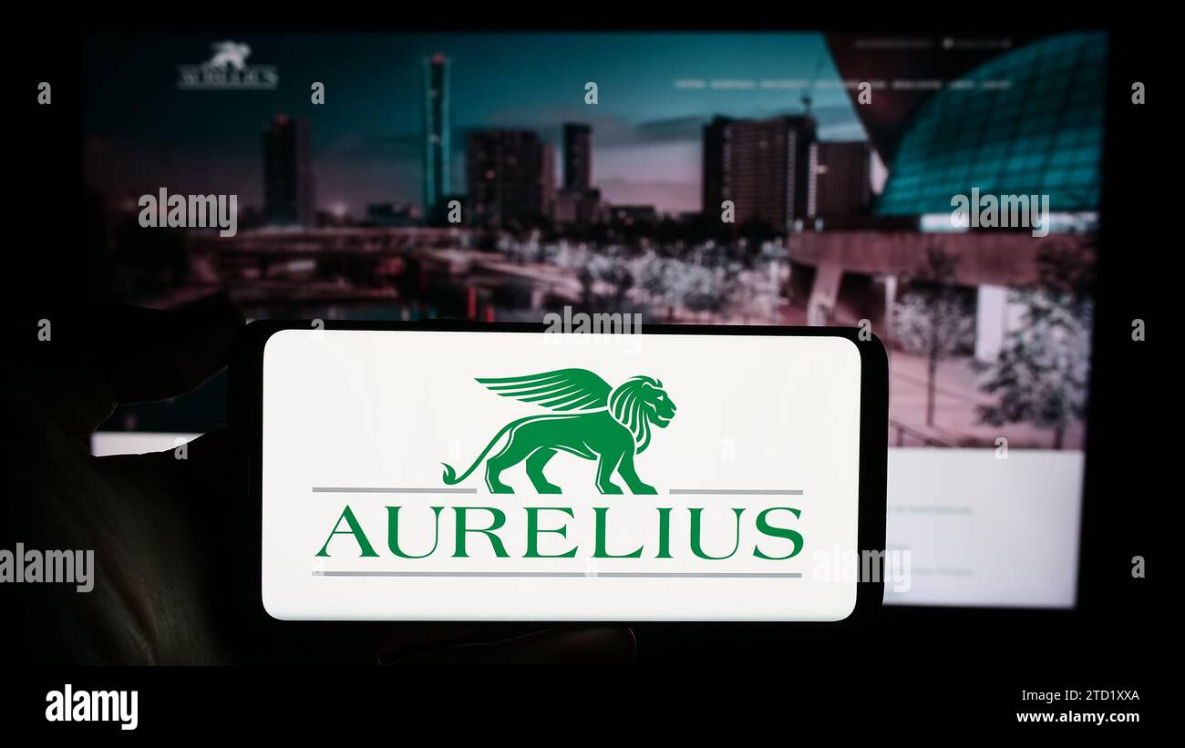 Person holding cellphone with logo of European investment company ...