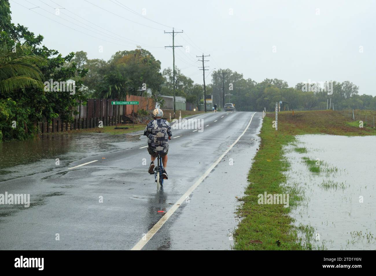 December 15, 2023, Cairns, Queensland, Australia: A man cycles along a ...