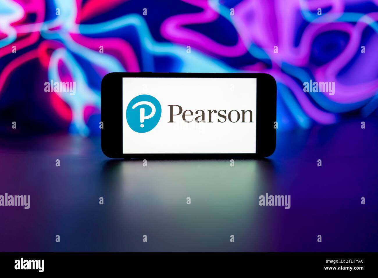 In this photo illustration, the Pearson logo is seen displayed on a ...