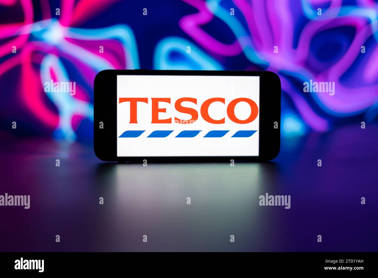 In this photo illustration, the Tesco logo is seen displayed on a ...