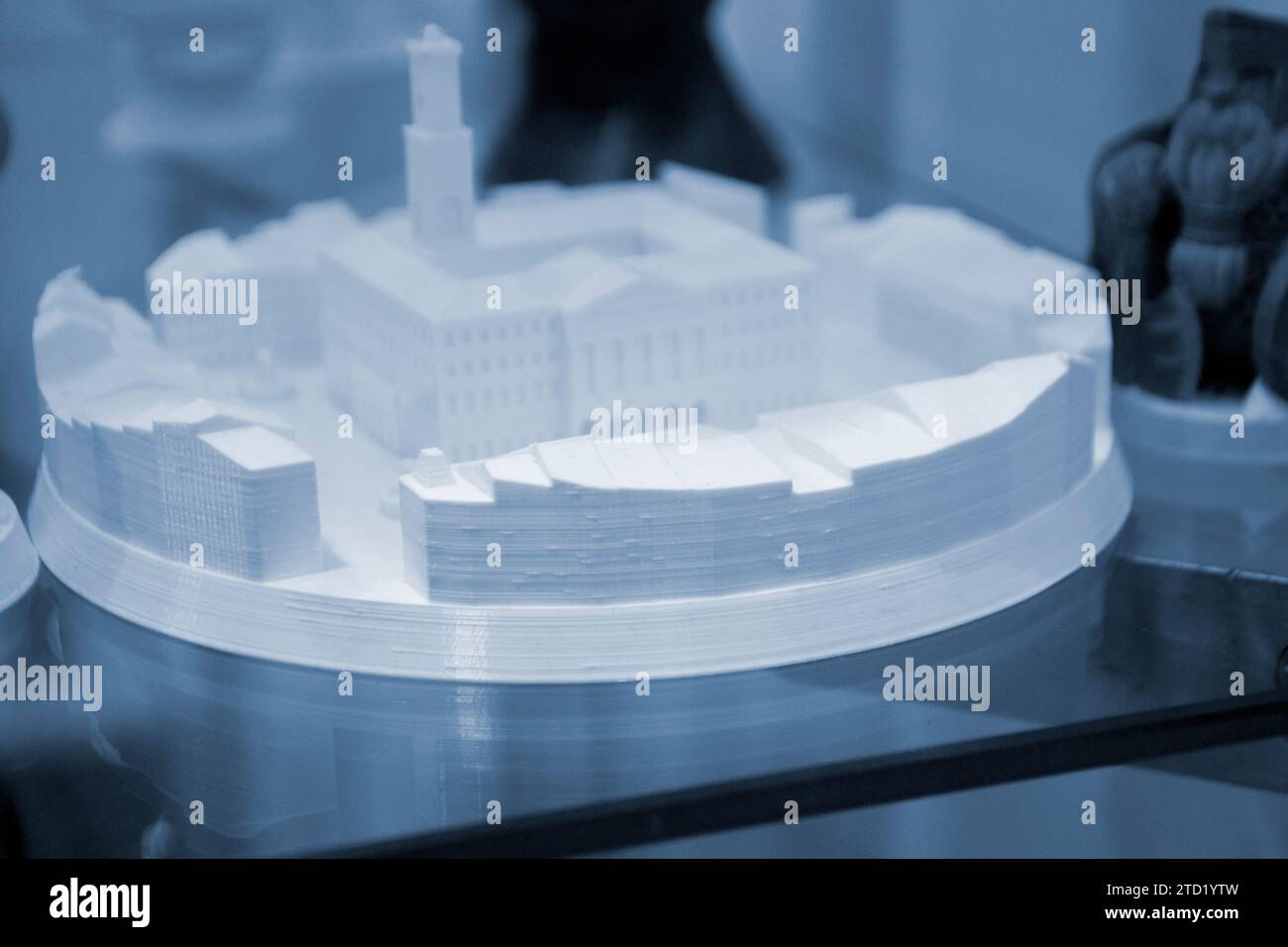 Prototype of building 3D printed from melted white plastic. Close-up ...