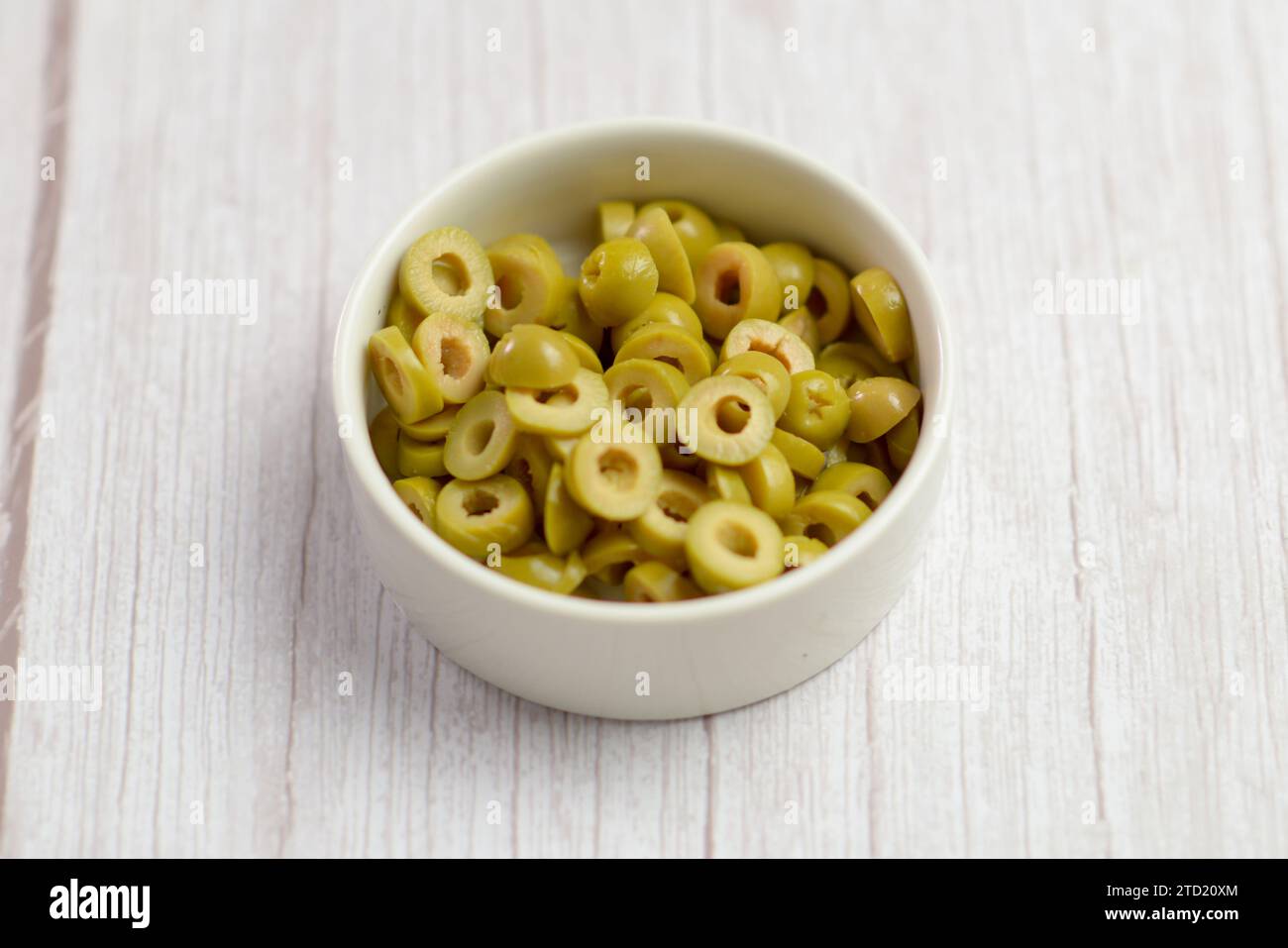 Chopped green olives in a white ceramic bowl, kitchen close-up Stock ...