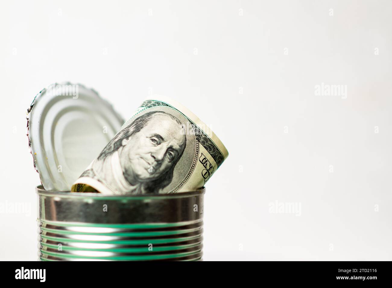 Dollars in an open tin can. Safeguarding cash, stash concept. Time to ...