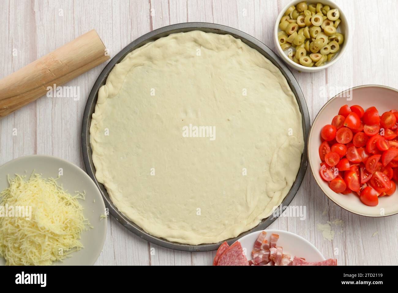 Various pizza components surrounding the pizza dough foundation Stock ...