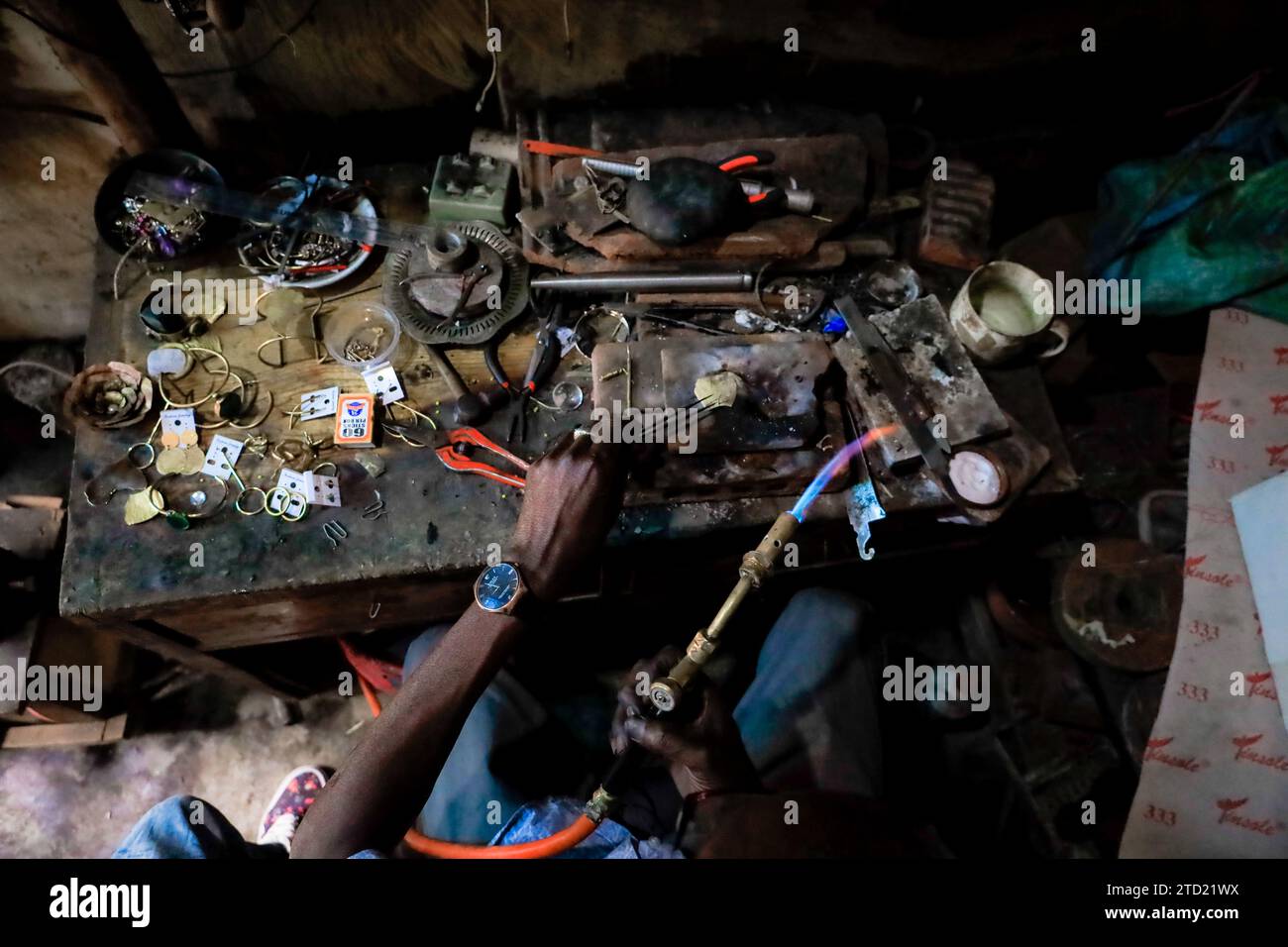 Samwel Mwangi makes jewelries at his shop in Kibera Slum on October 25, 2023 in Nairobi, Kenya ...