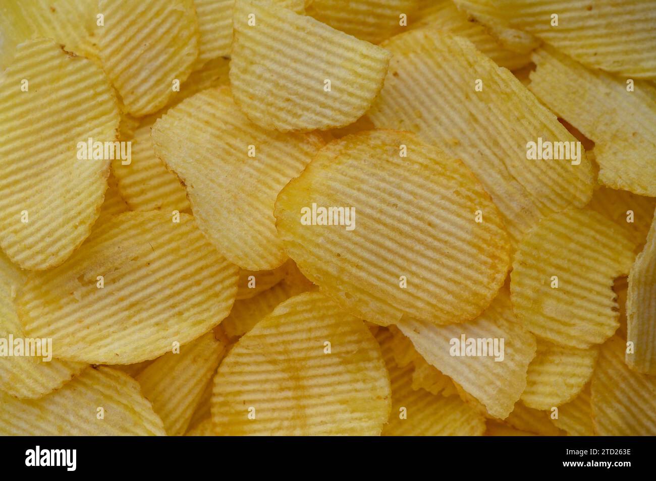 food background from delicious chips poured out of a pack Stock Photo ...