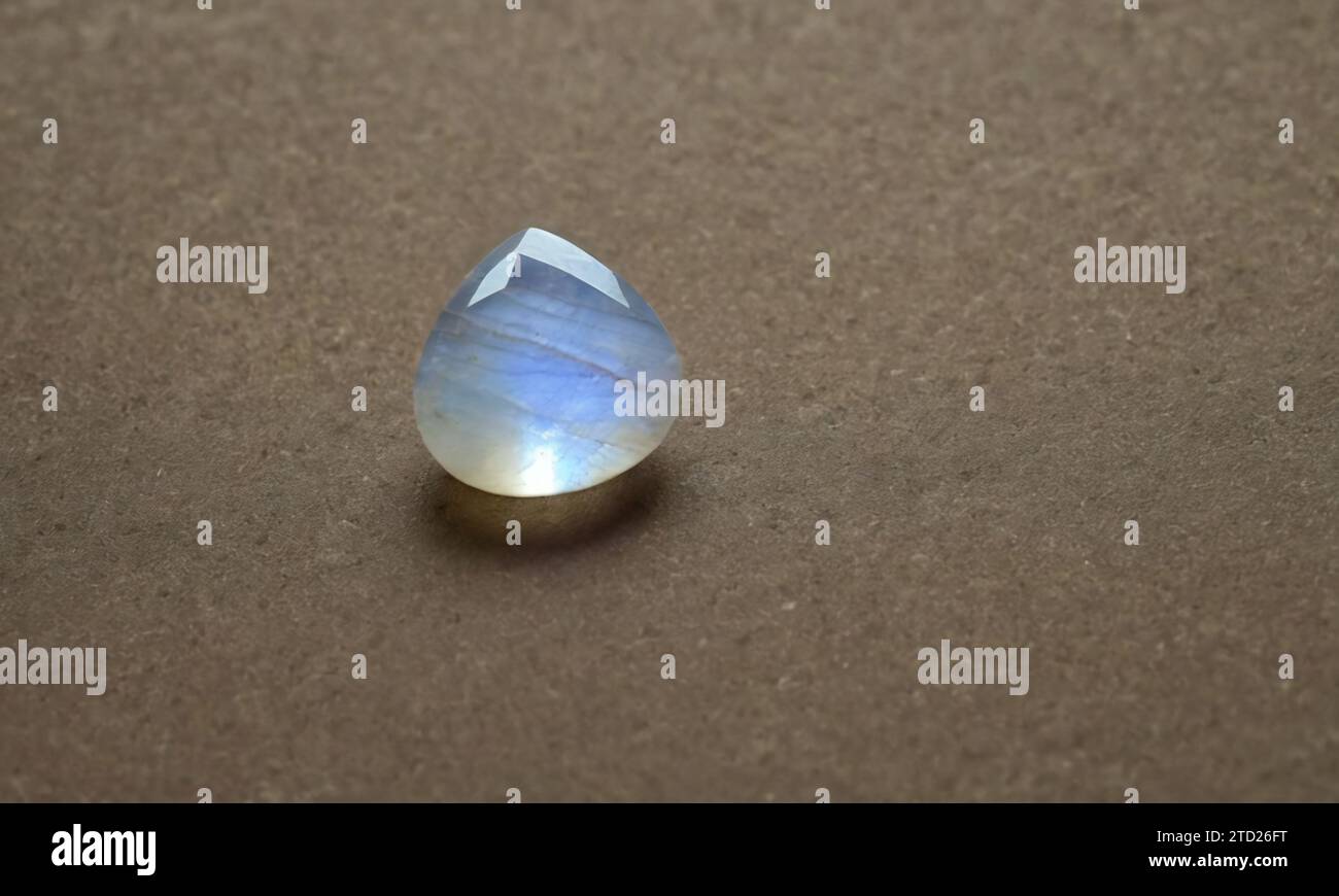 Natural precious moonstone on a brown background. Natural stone ...