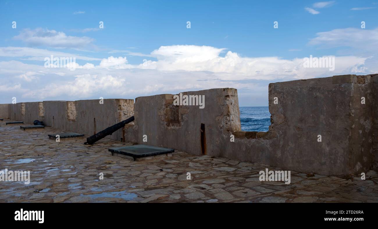 Firkas Fortress worn wall, antique cannon on paved yard at Old Town of ...