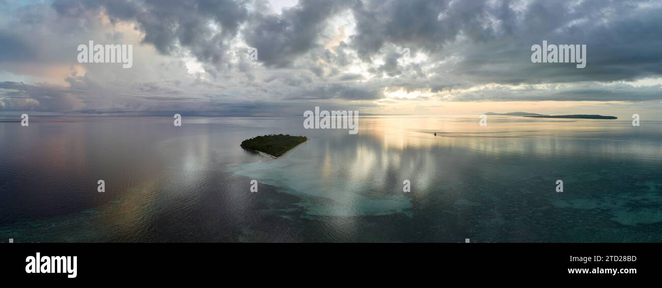 Sunrise illuminates the remote island of Koon near Seram, Indonesia ...