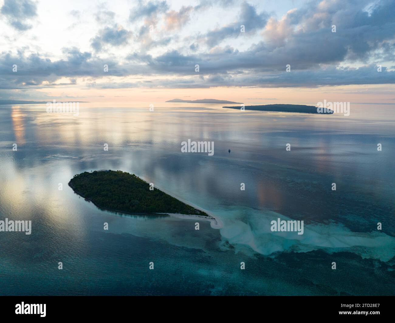 Sunrise illuminates the remote island of Koon near Seram, Indonesia ...