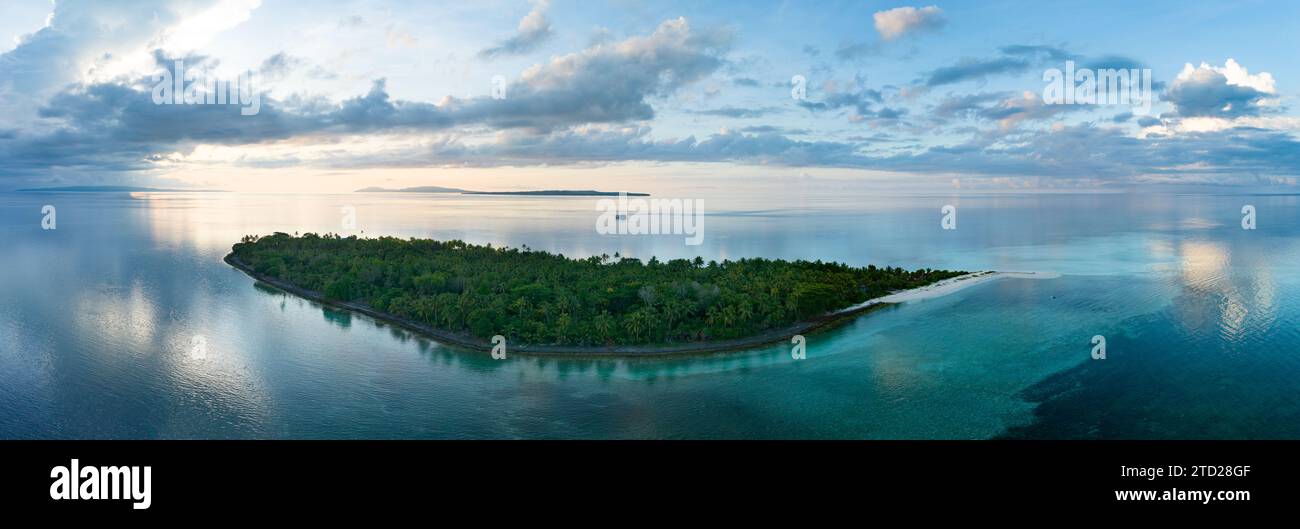 Sunrise illuminates the remote island of Koon near Seram, Indonesia ...